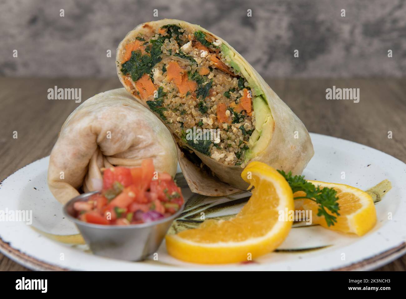 Vegan burrito cut in half to show the healthy non-meat ingredients of ...