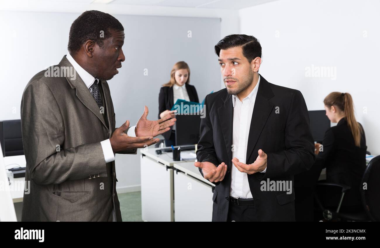 Angry man boss pointinting to misses in work to man Stock Photo - Alamy