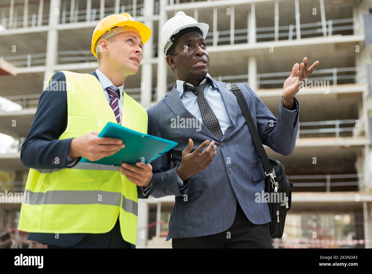 Foreman and engineer talking about new building outdoors Stock Photo ...