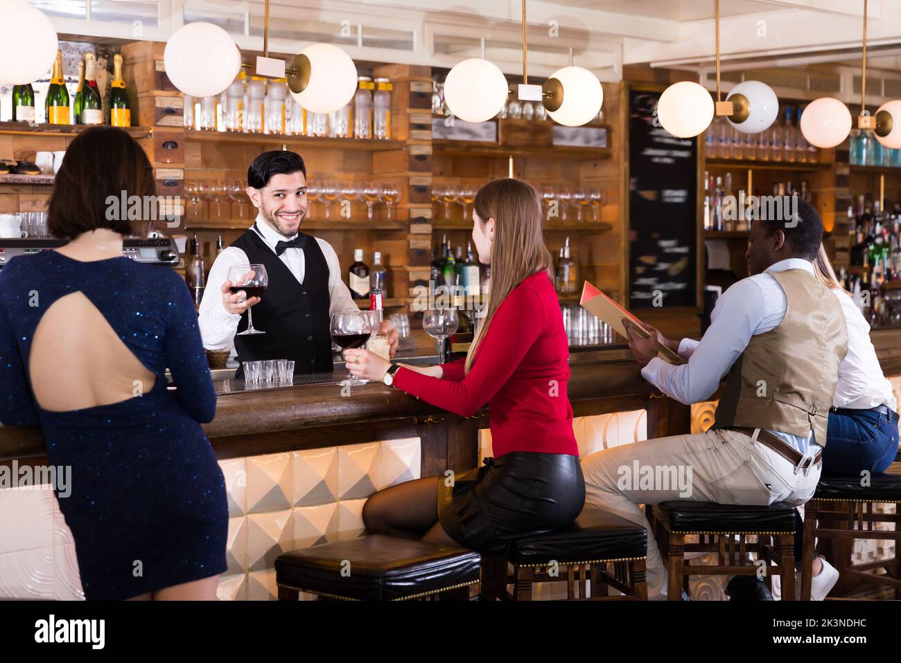 Adult people are relaxing near bar counter Stock Photo - Alamy