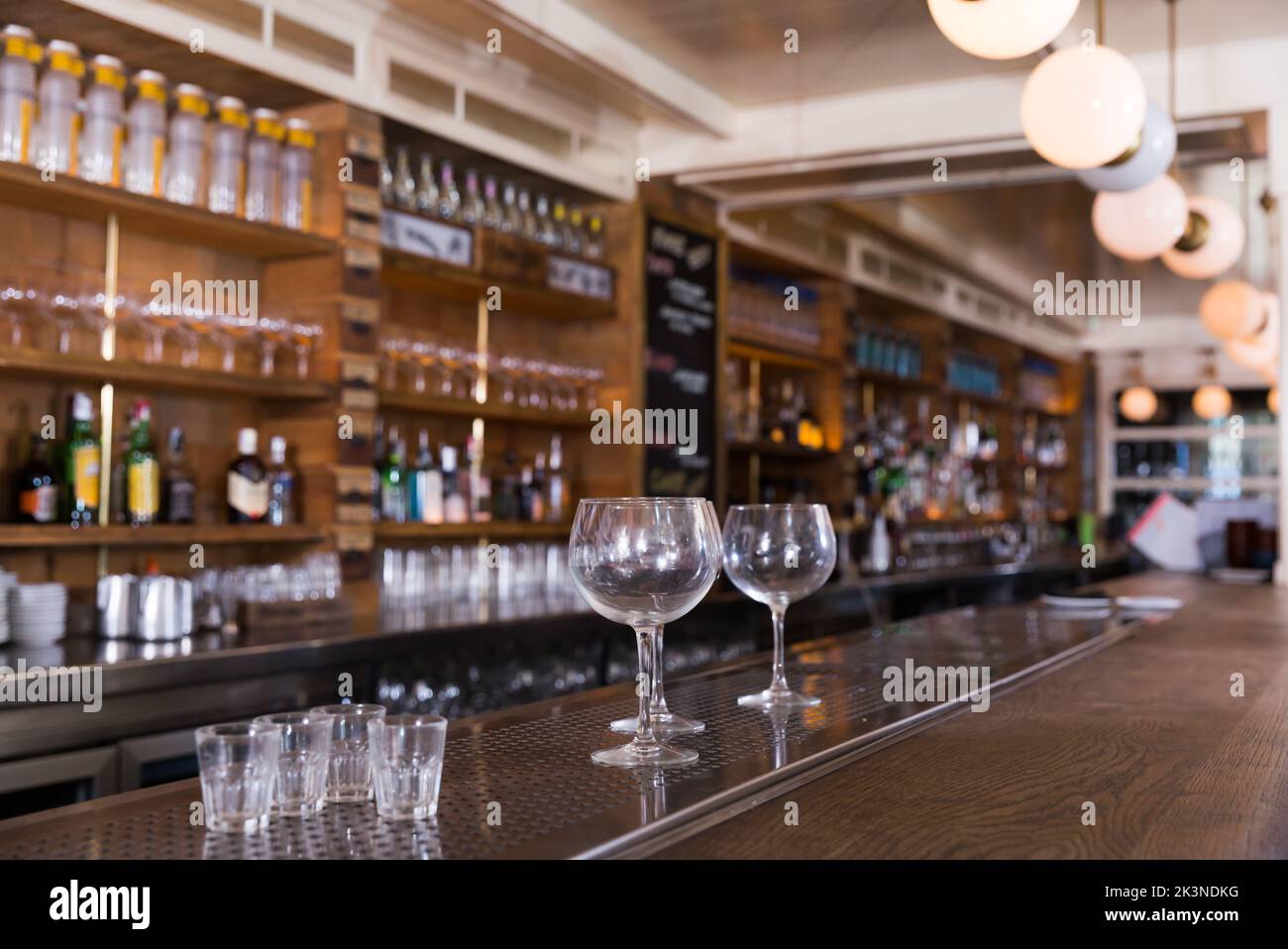 Empty wine glasses at bar counter Stock Photo - Alamy