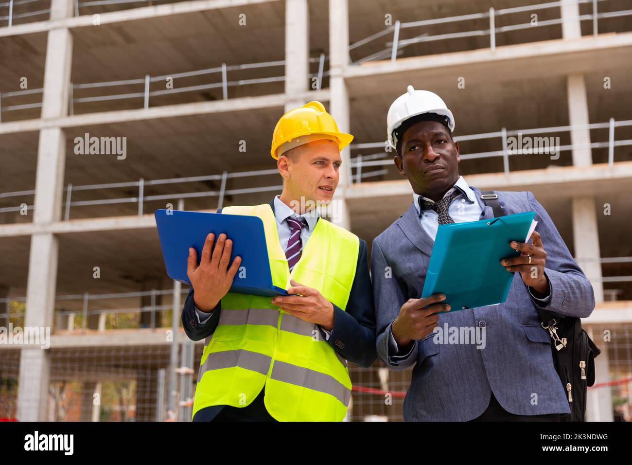 Architect and foreman must write documents and drawings on laptop with ...