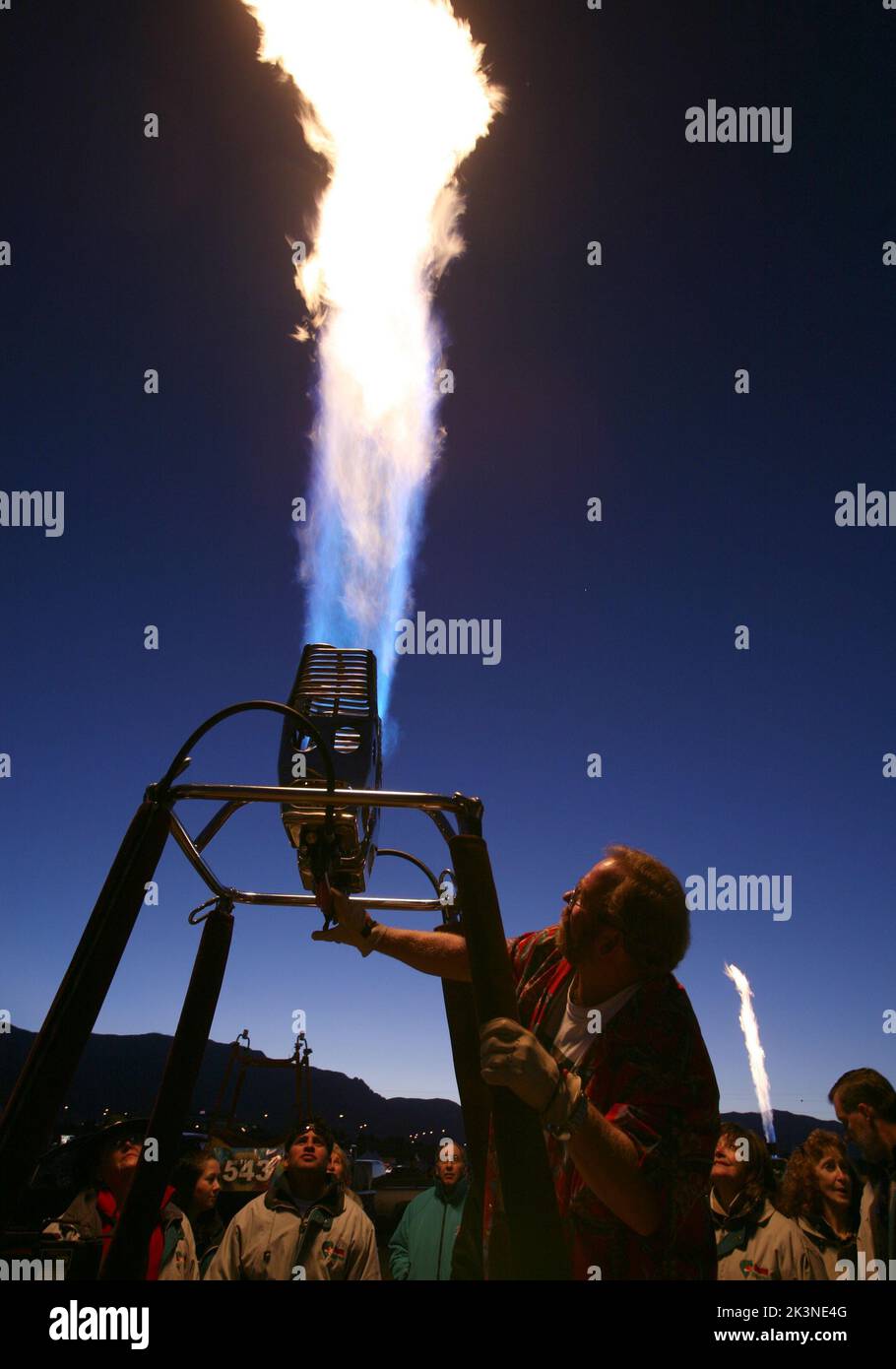 A pilot tests and lights up the propane burner on his hot air balloon ...