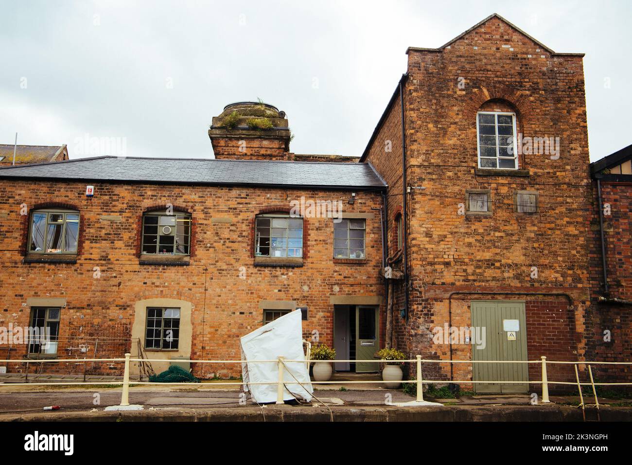A scenery of red brick dock buildings Stock Photo - Alamy