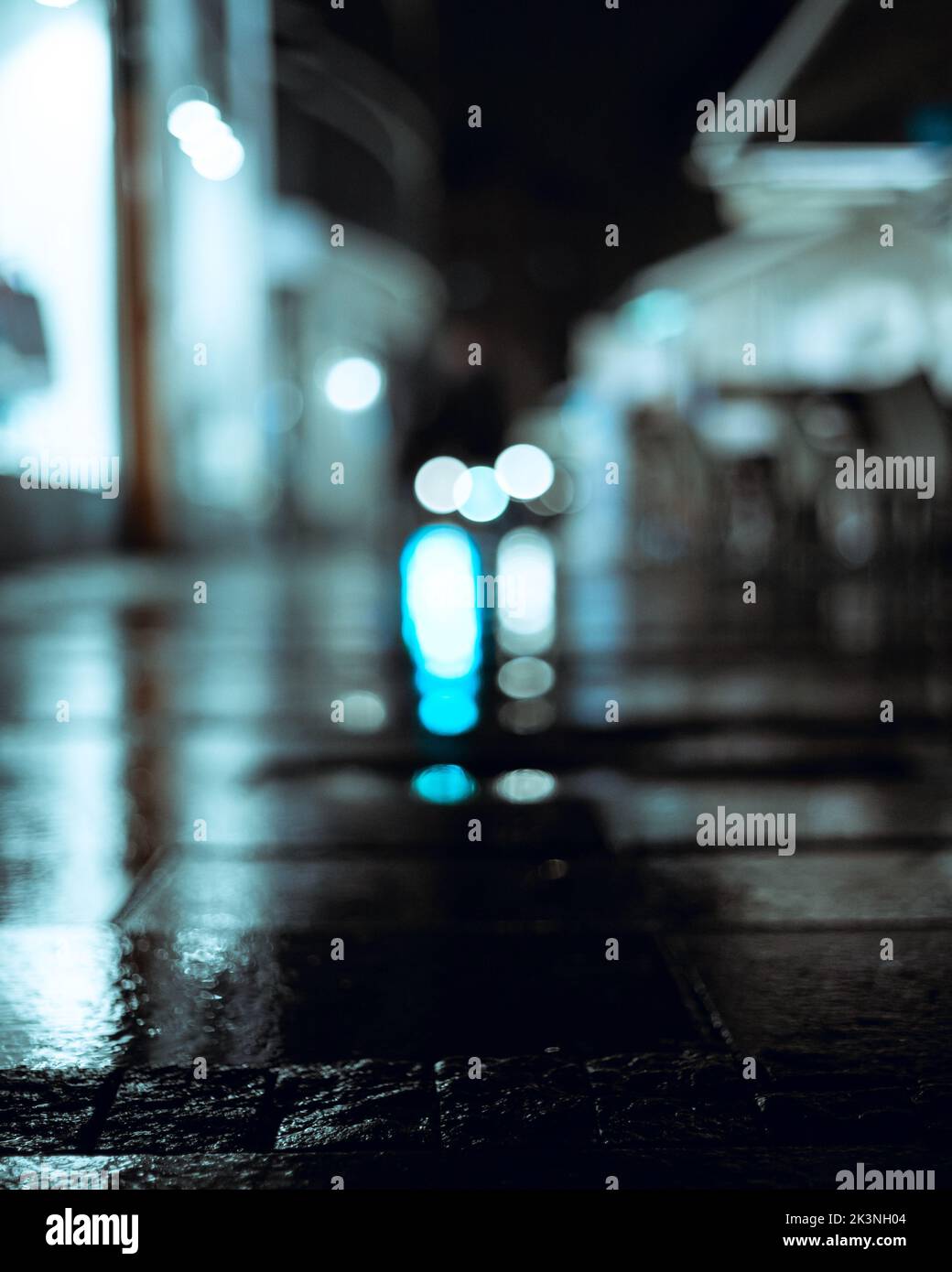 A vertical shot of blur raindrops falling on wet asphalt ground Stock ...