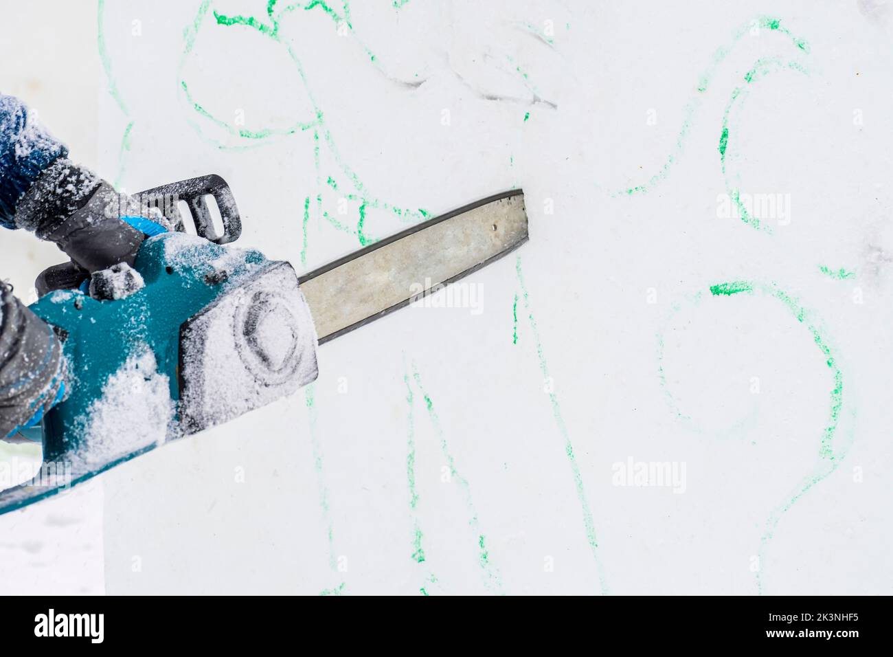 Making Christmas decorations. Master sculptor carves ice sculpture with ...