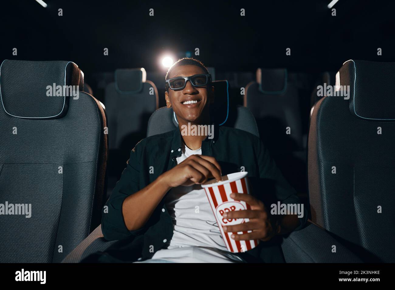 african american man in 3d glasses eating popcorn and watching film in cinema Stock Photo - Alamy