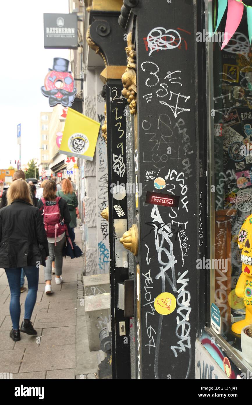 A vertical shot of graffiti and wallpaintings in an urban overcrowded ...