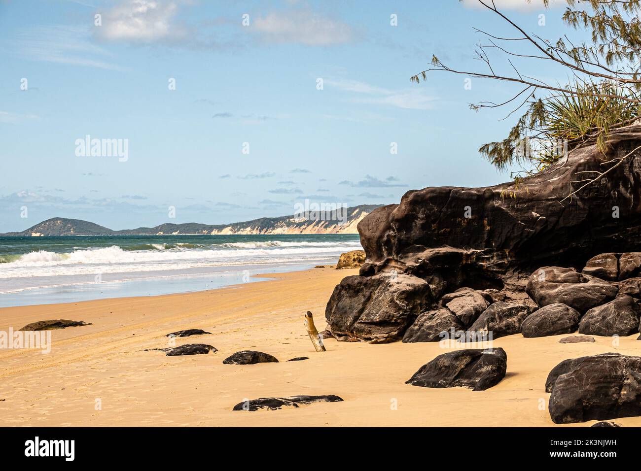 beach with dark rocks Stock Photo - Alamy