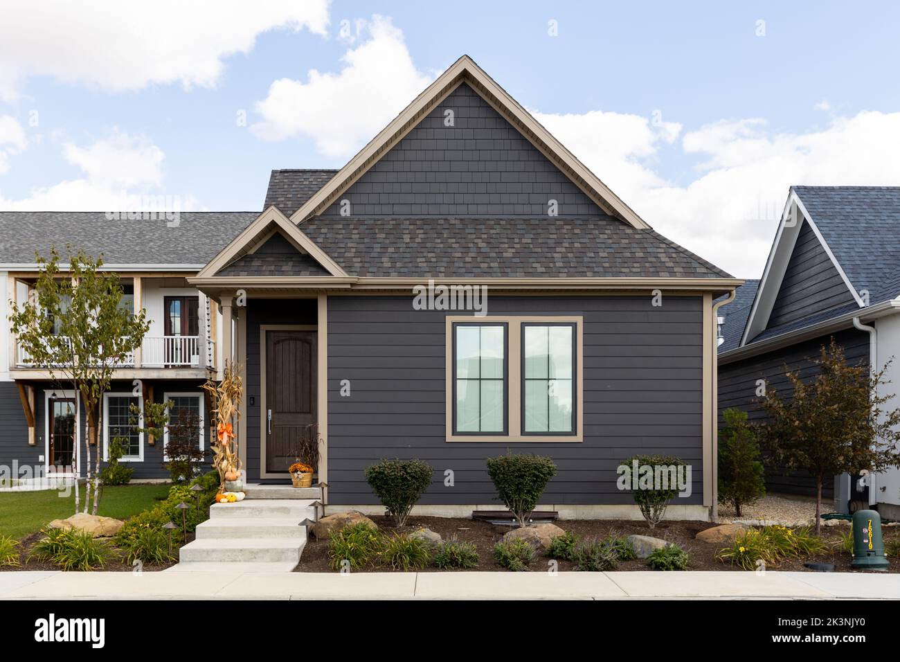 A dark brown ranch home with light brown trim and accents Stock Photo ...