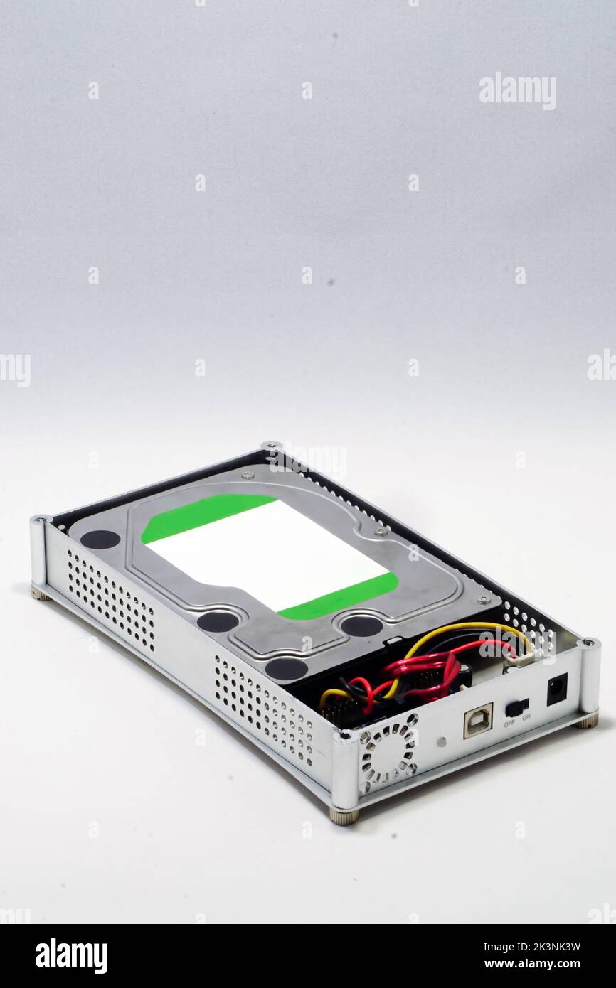 A vertical shot of an external HDD drive isolated on white background ...