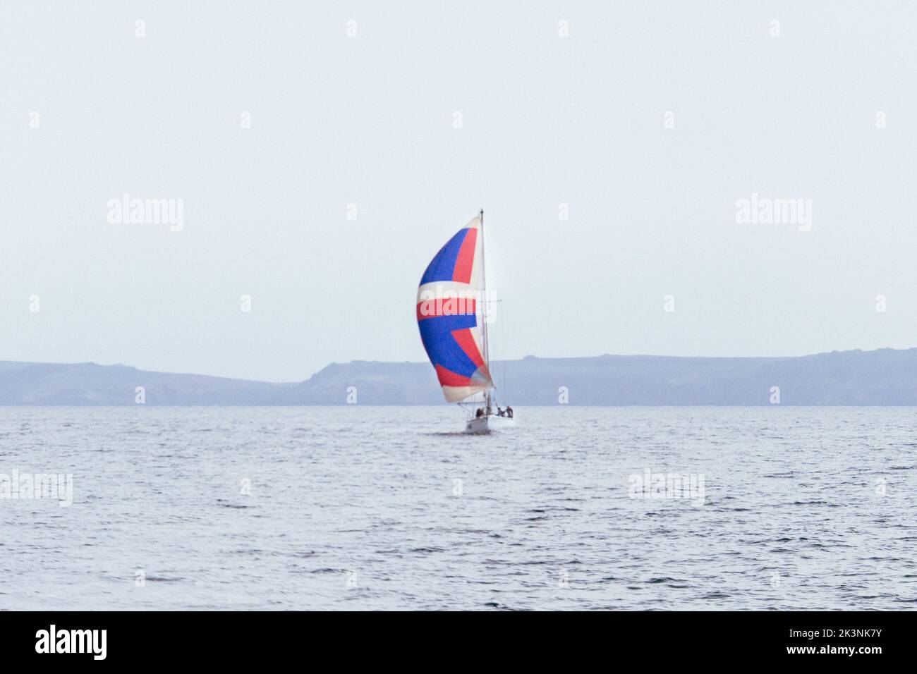 A sailing boat with a colorful spinnaker Stock Photo - Alamy