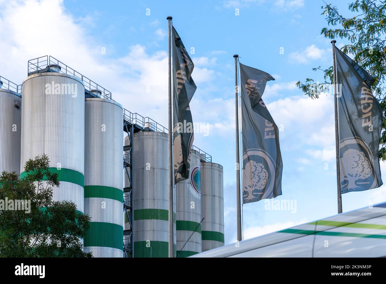The building of the Eichbaum brewery with silos and flags produces a ...