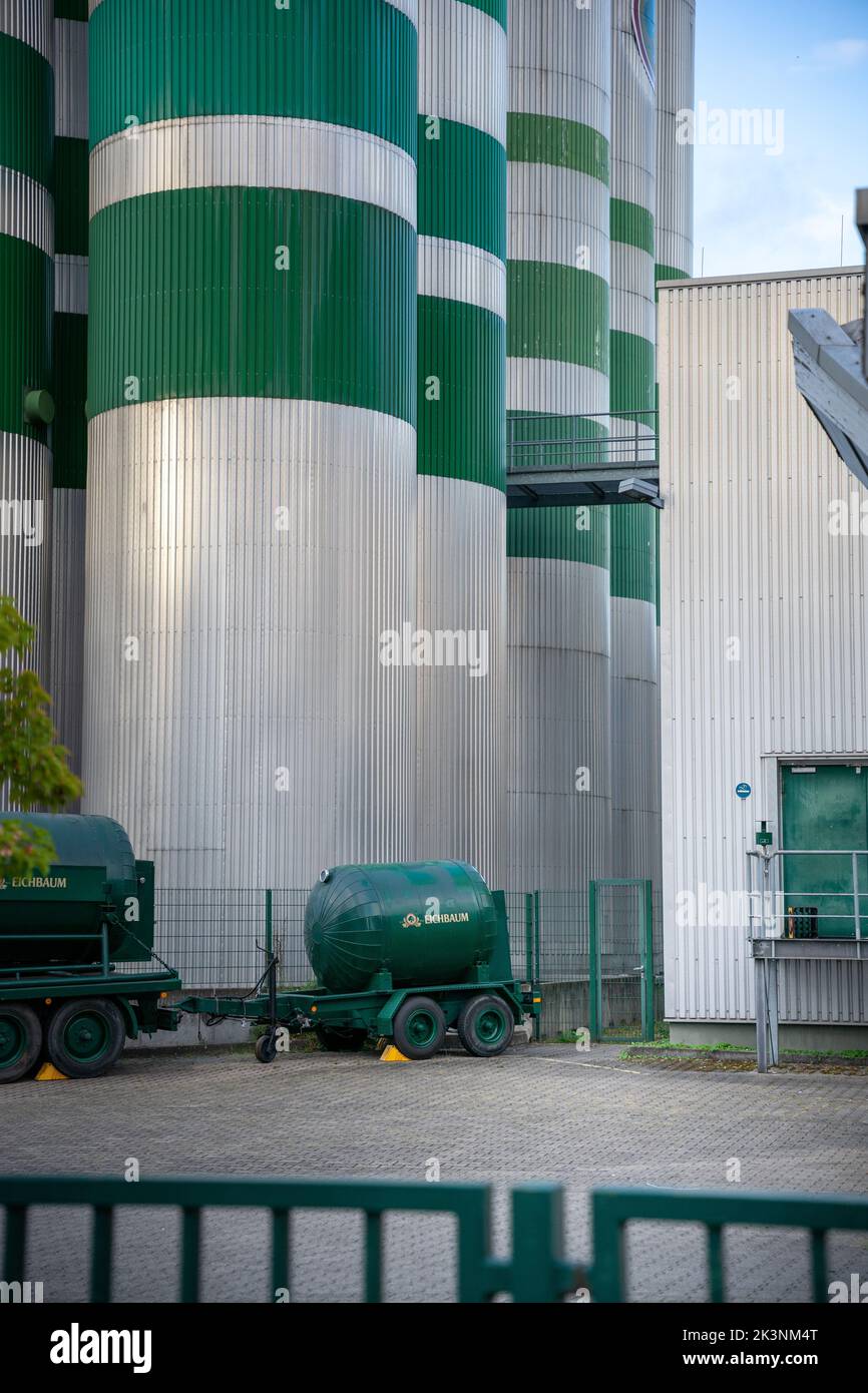 The building of the Eichbaum brewery with silos and flags produces a ...