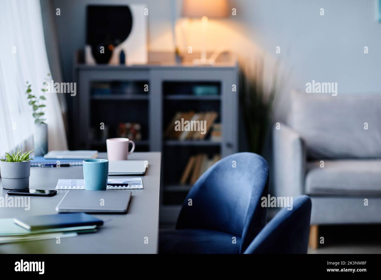 Background image of modern home interior with workplace in dark blue ...