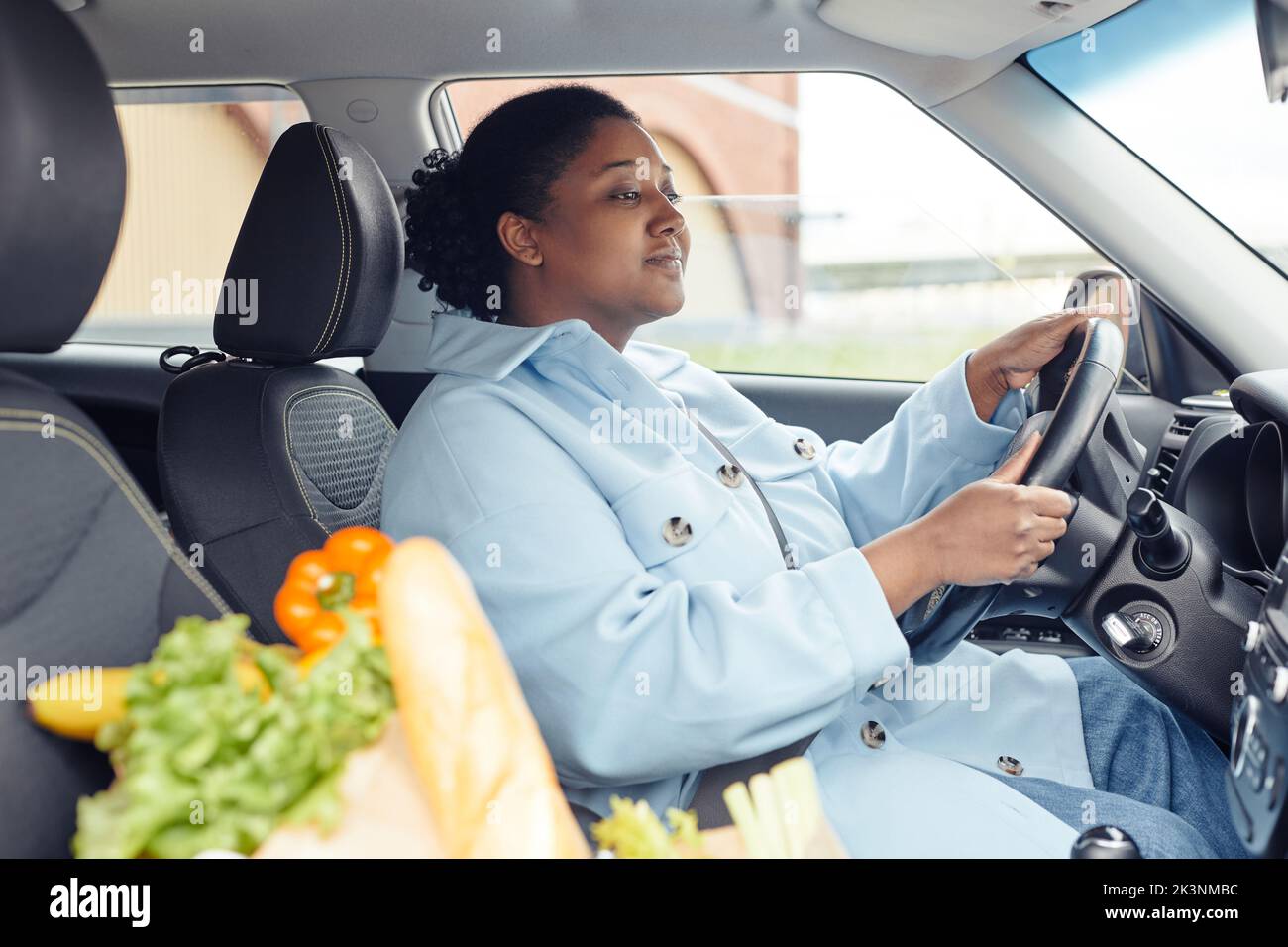 Young black woman driving hi-res stock photography and images - Alamy