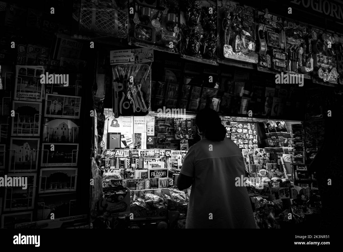 Customer waiting to buy a newspaper at night Stock Photo - Alamy