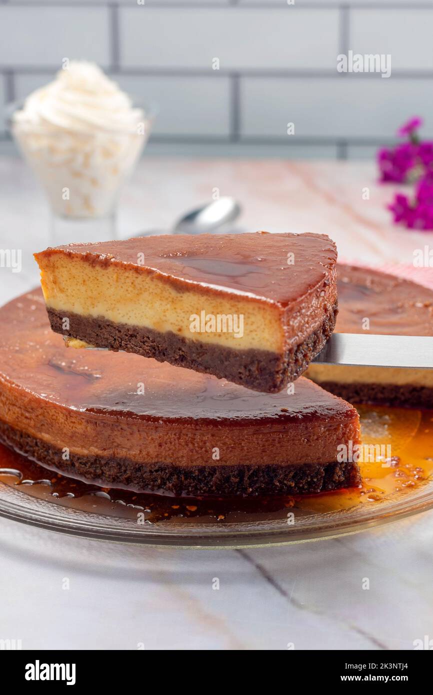 A vertical shot of a chocolate and flan dessert inverted cake with ...