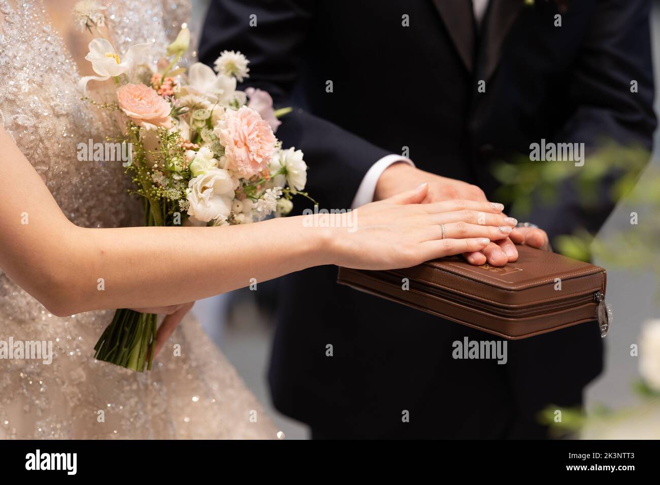 Bride and Groom with hands on bible, wedding ceremony in the church ...