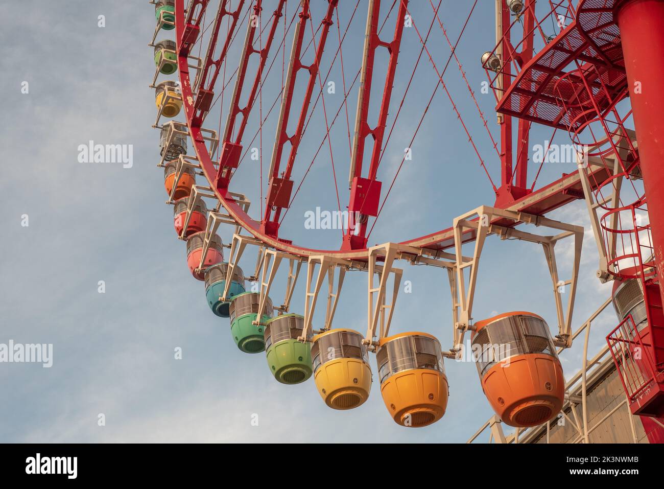 A colorful Daikanransha Ferris Wheel under a clear sky Stock Photo - Alamy