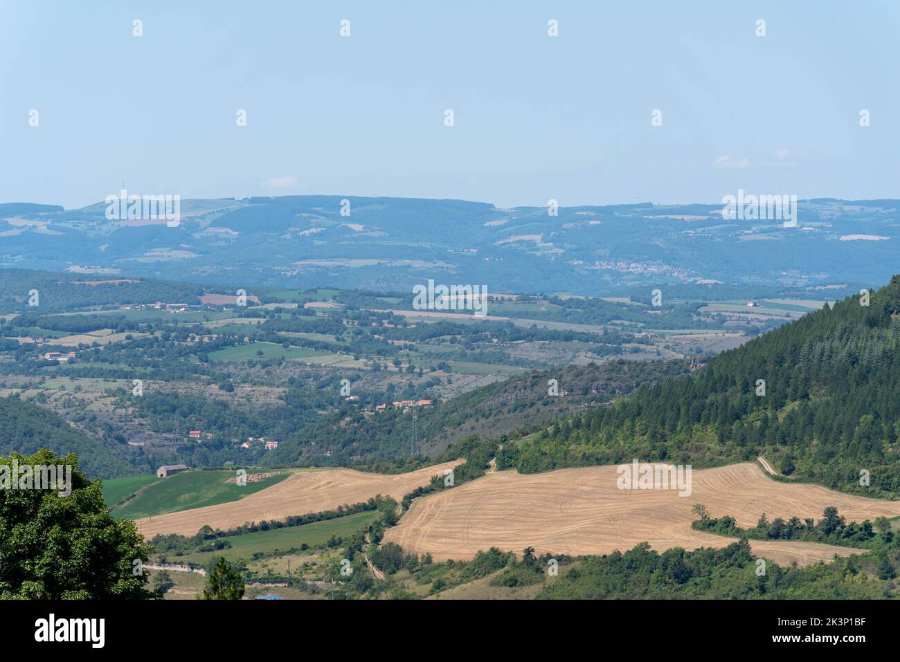 A beautiful view of a green valley with a cloudless blue sky background ...