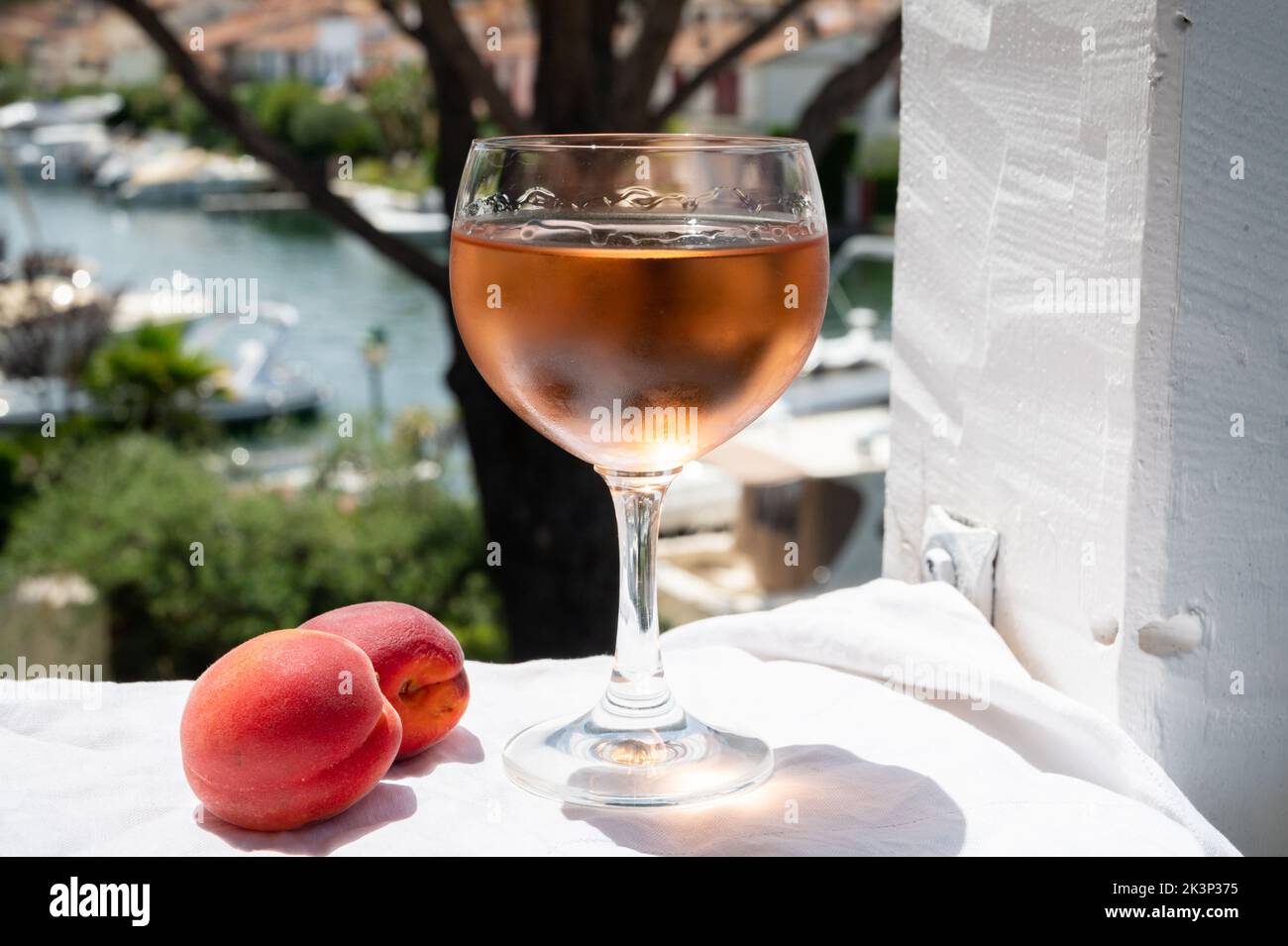 Drinking of cold rose wine from Provence with red apricots and view on ...