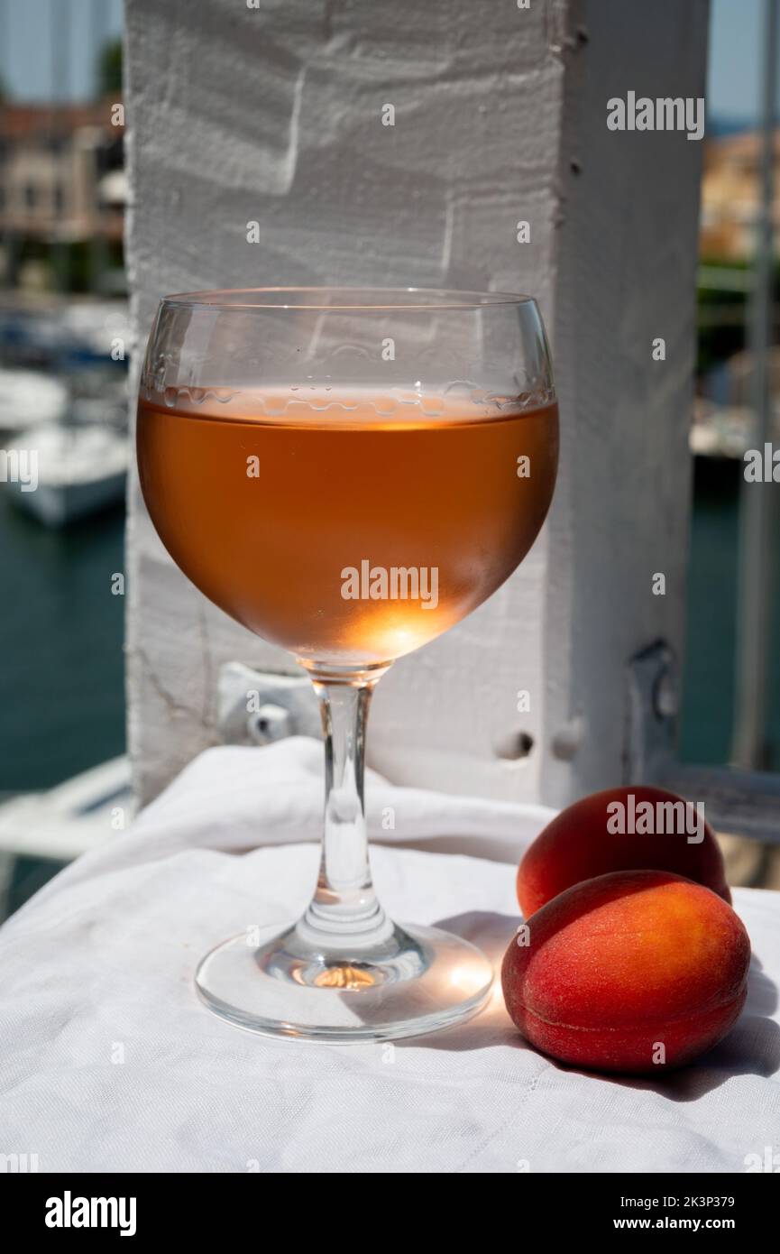 Drinking of cold rose wine from Provence with red apricots and view on ...