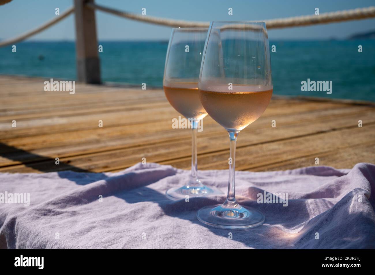 Glasses of cold rose wine from Provence served outdoor on wooden yacht ...