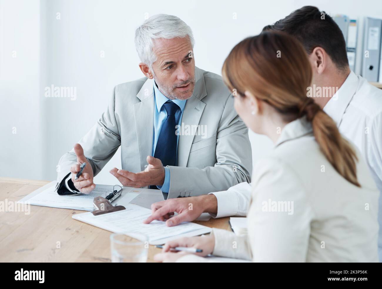 The weekly board room meeting has started. a group of colleagues having ...