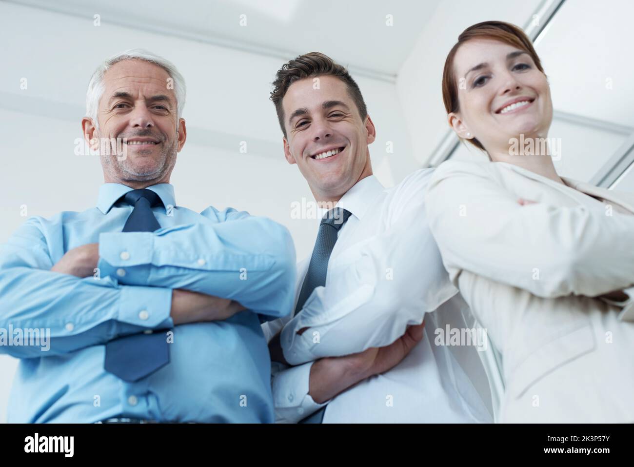 Well get it done. a three corporate coworkers in an office Stock Photo ...