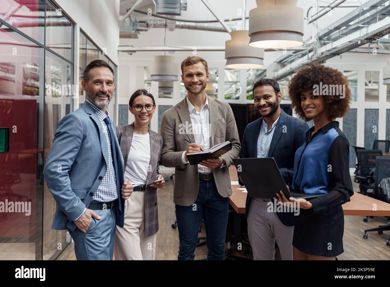 Group of happy, motivated business people standing together at office ...