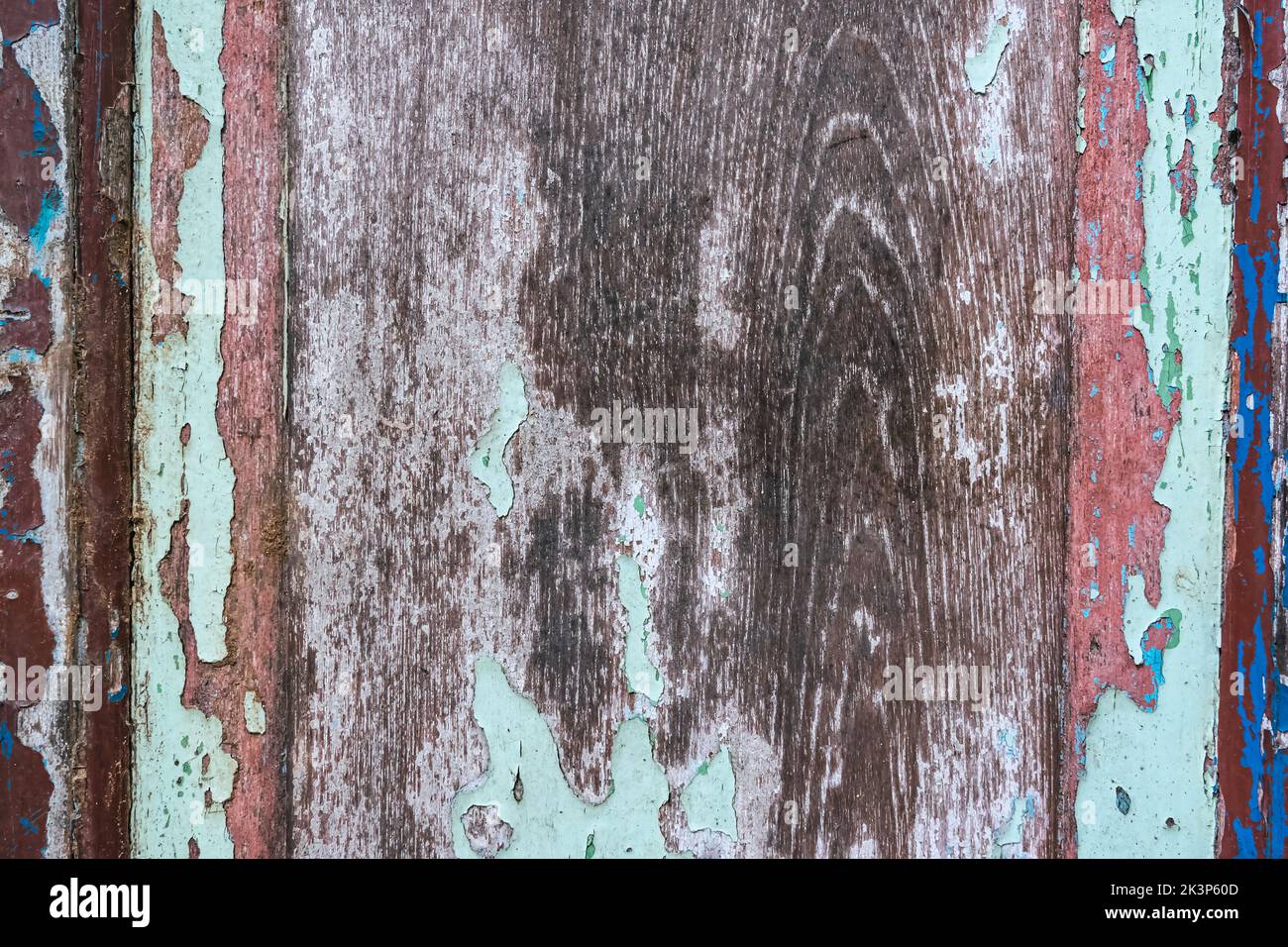 Colorful craquelure of the delaminated paint on wooden door background ...