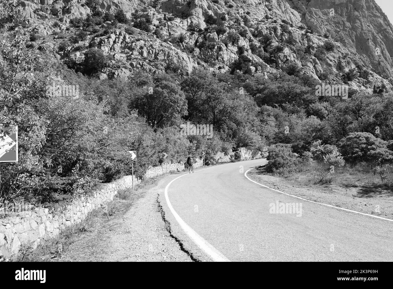 sharp road turn in mountains, summertime outdoor shot in black and ...