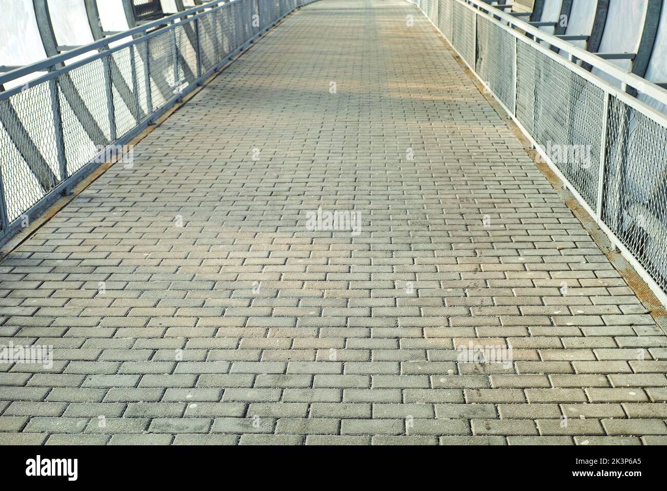 a modern pedestrian bridge with a tiled floor and glass walls Stock ...