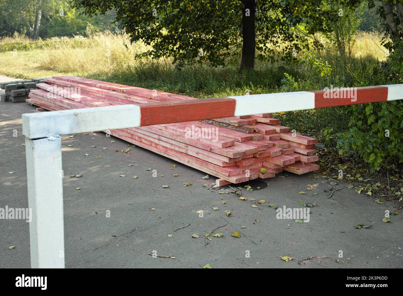 a road barrier and a stack of painted wood boards, a daytime shot Stock ...