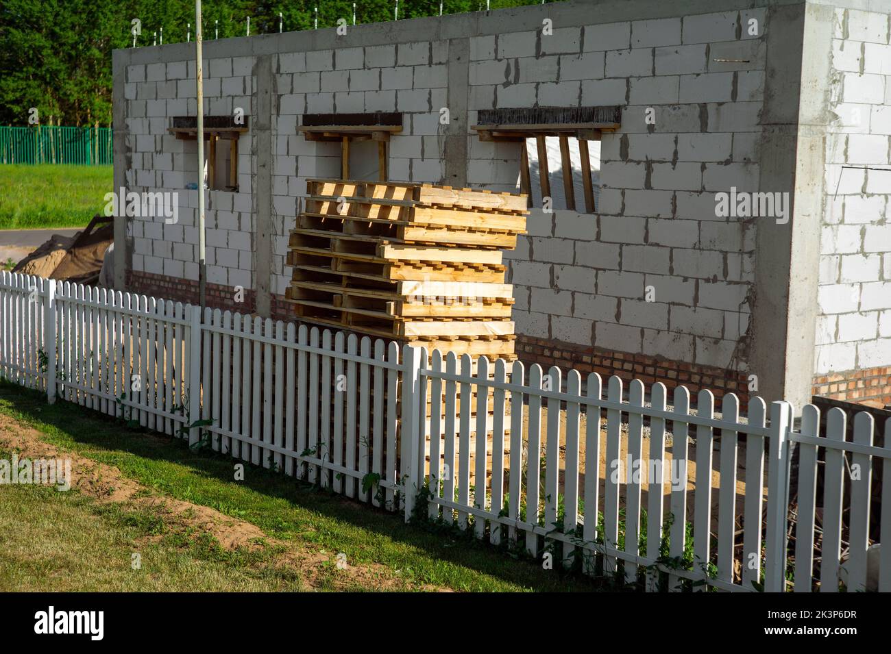 concrete blocks unfinished house without windows and a stack of euro ...