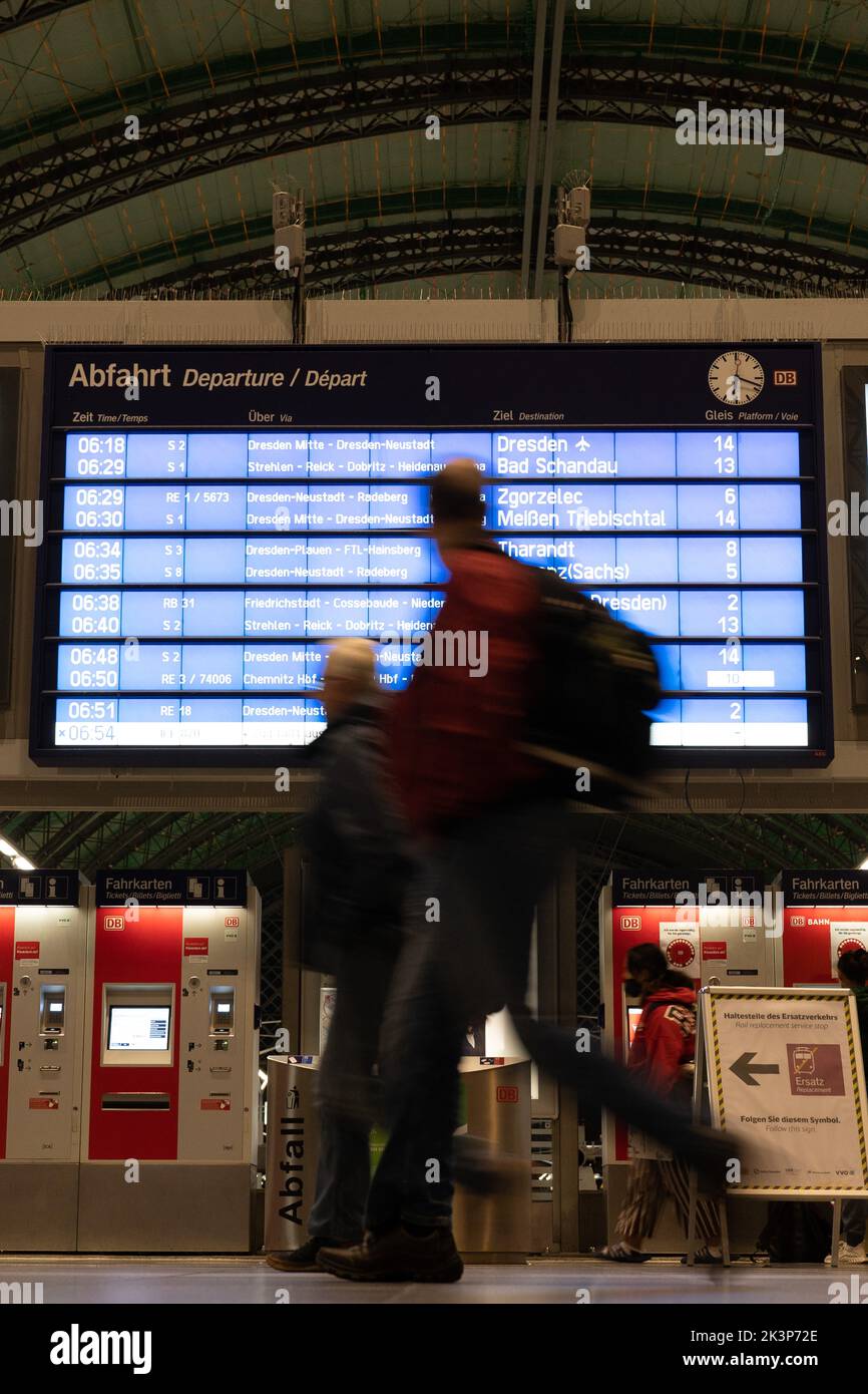 Dresden, Germany. 28th Sep, 2022. Passers-by walk past a digital ...