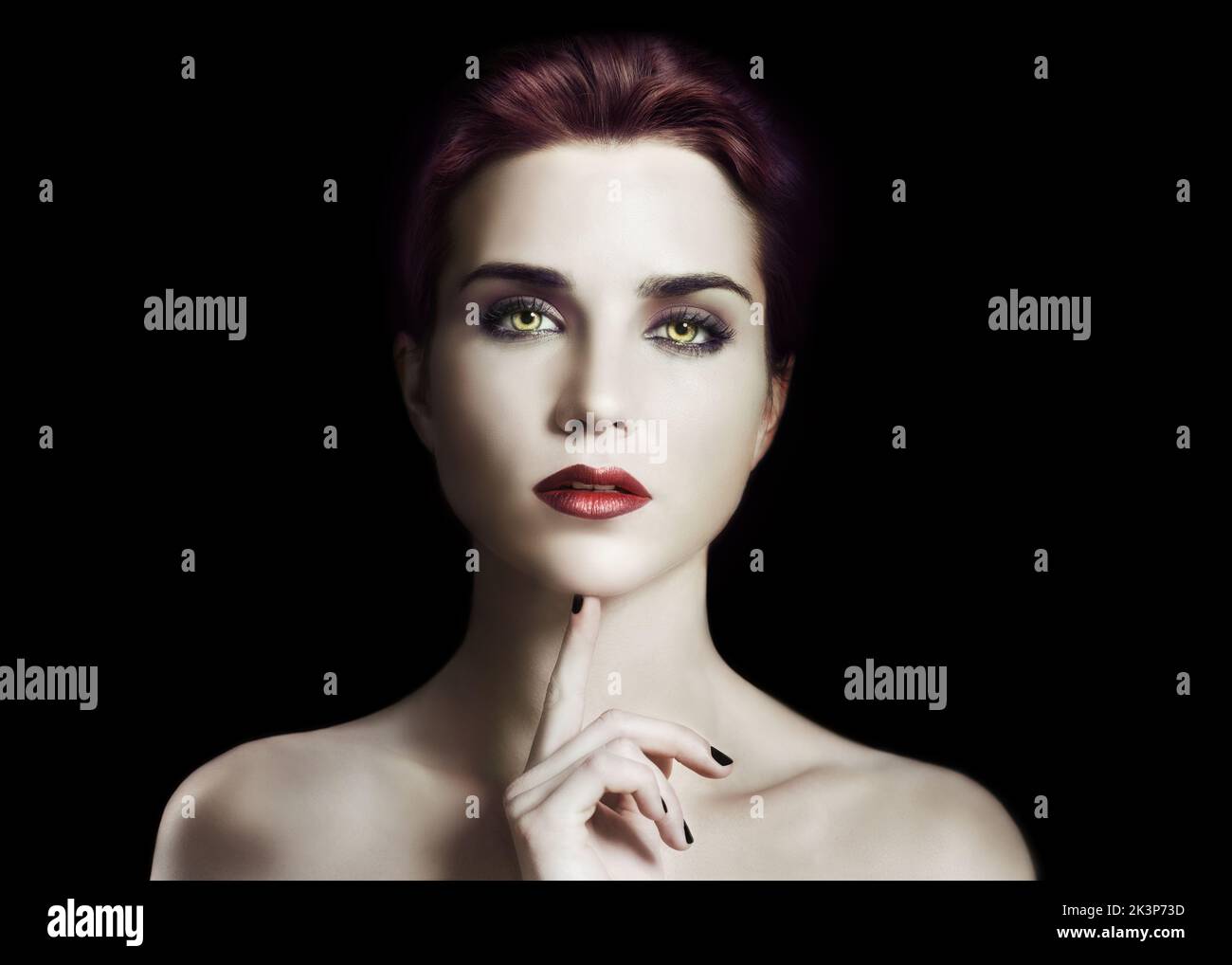 Dark and gothic style in studio. A fiery gothic girl posing on a black ...