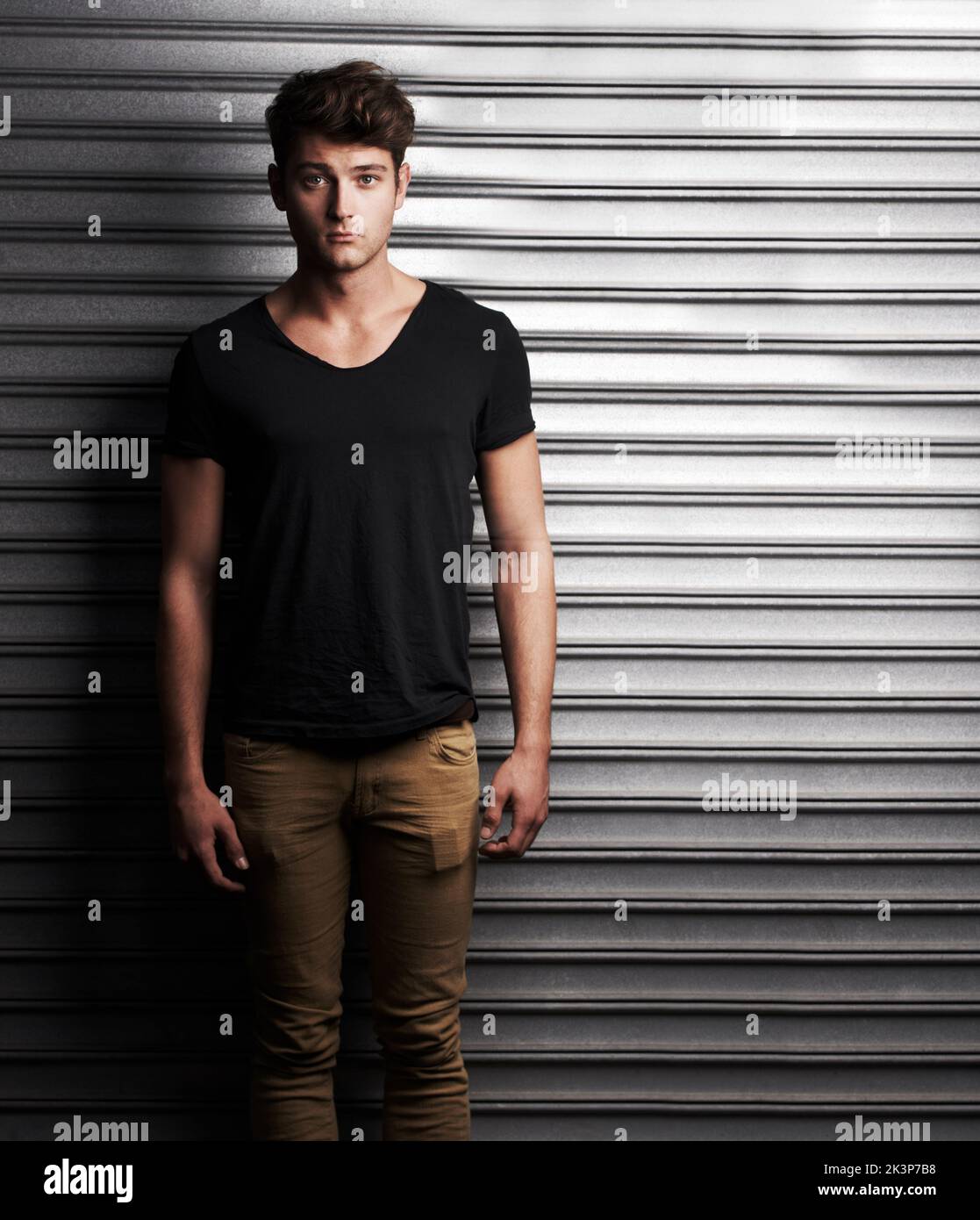 Keeping it all locked up. a handsome young man standing in front of a ...