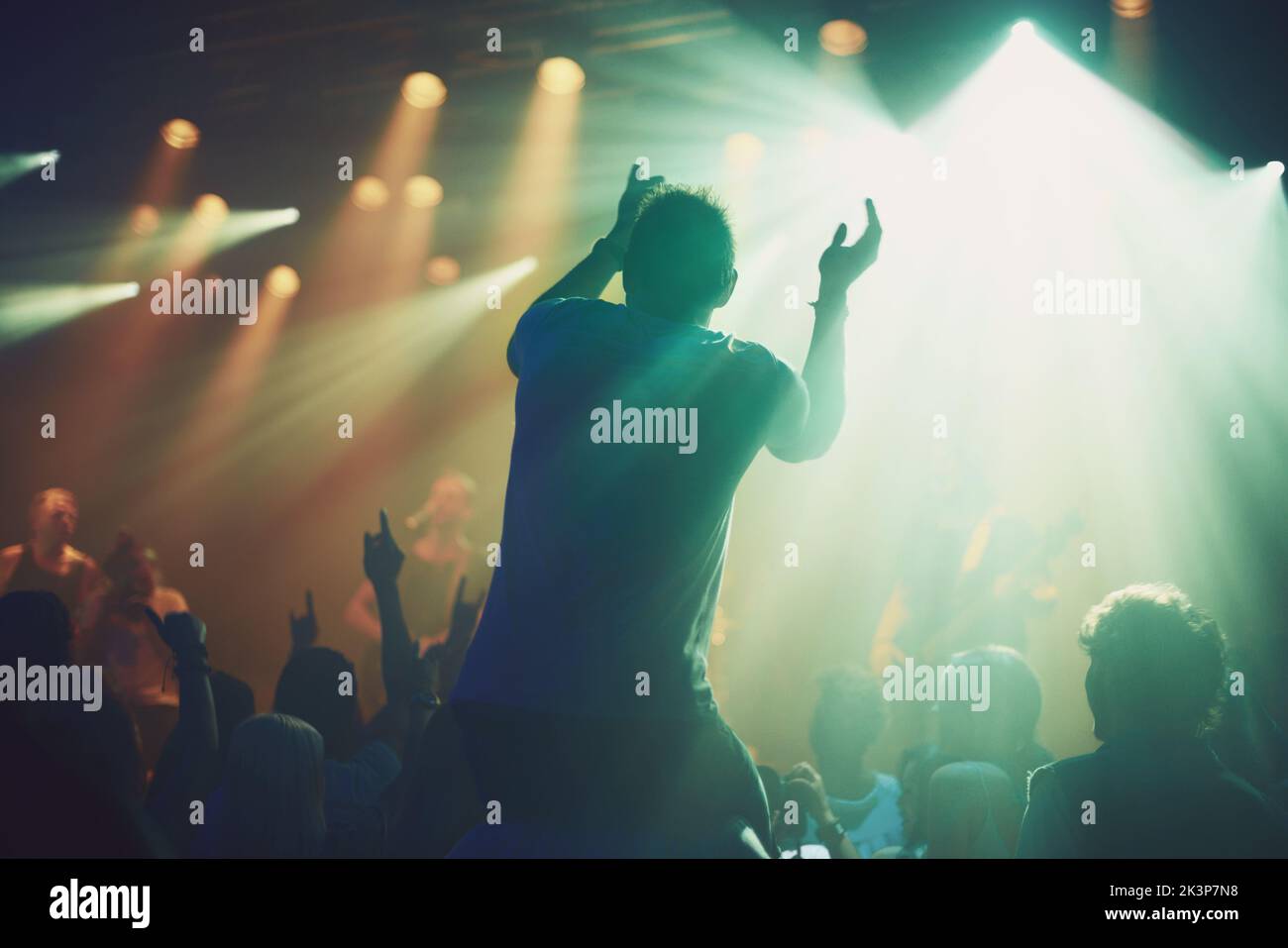 Everybody clap your hands. An excited young man cheering atop a friends ...