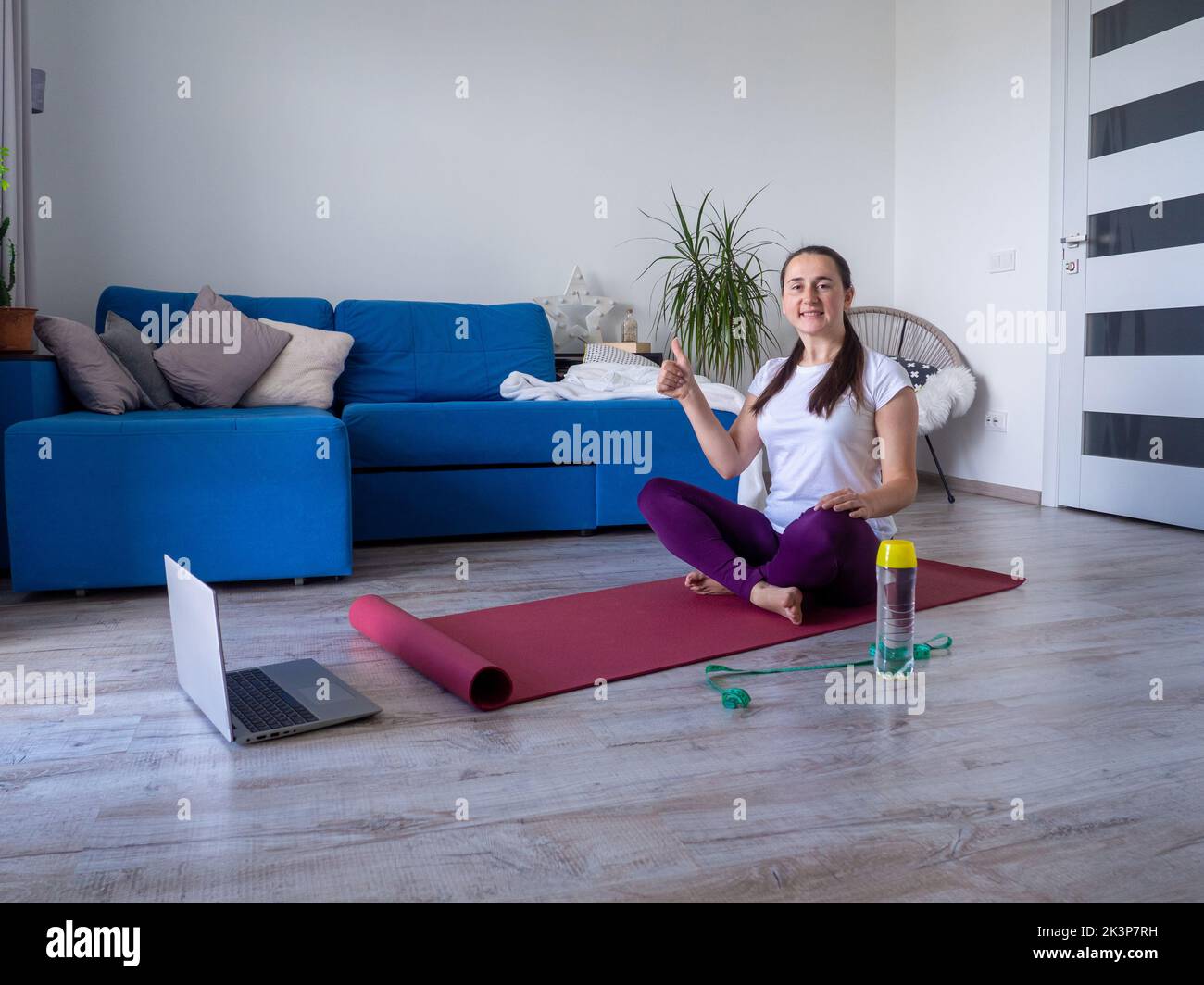 European girl showing like during practising yoga. Concept of fitness ...