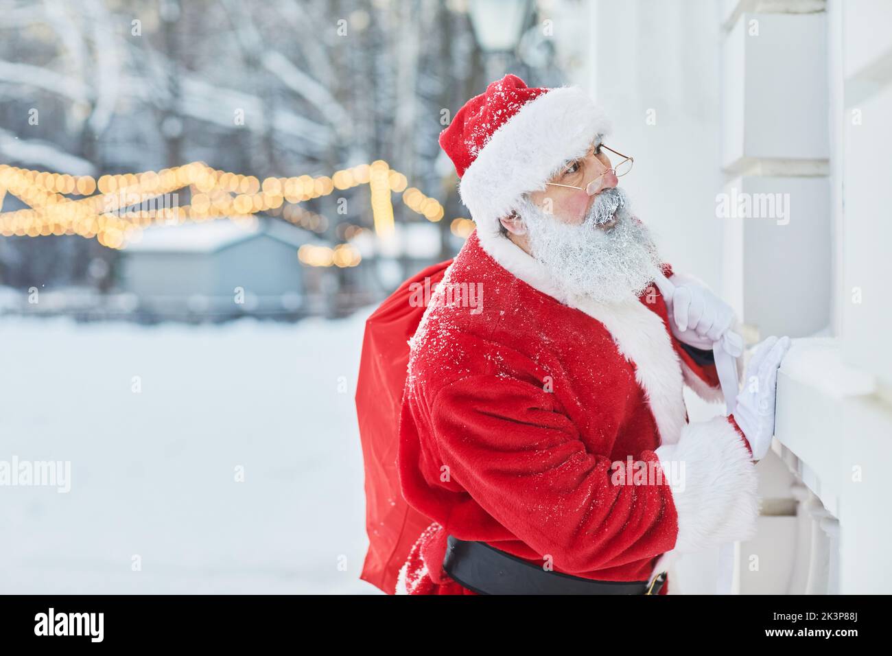 Side view portrait of traditional Santa Claus looking in windows on ...