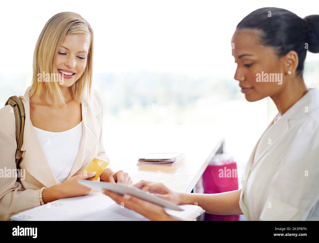 Receptionist standing in hotel lobby hi-res stock photography and ...