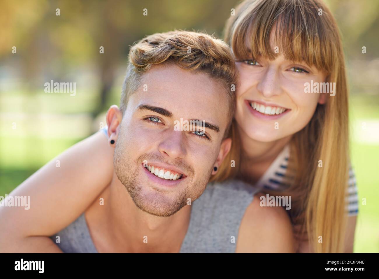 Smitten with new love. a young couple enjoying a day together in a park ...