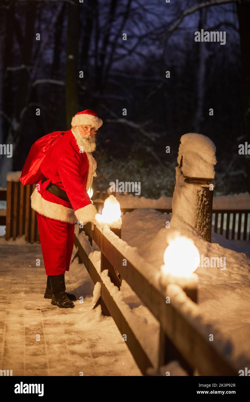 Vertical portrait of traditional Santa Claus with sack of presents ...