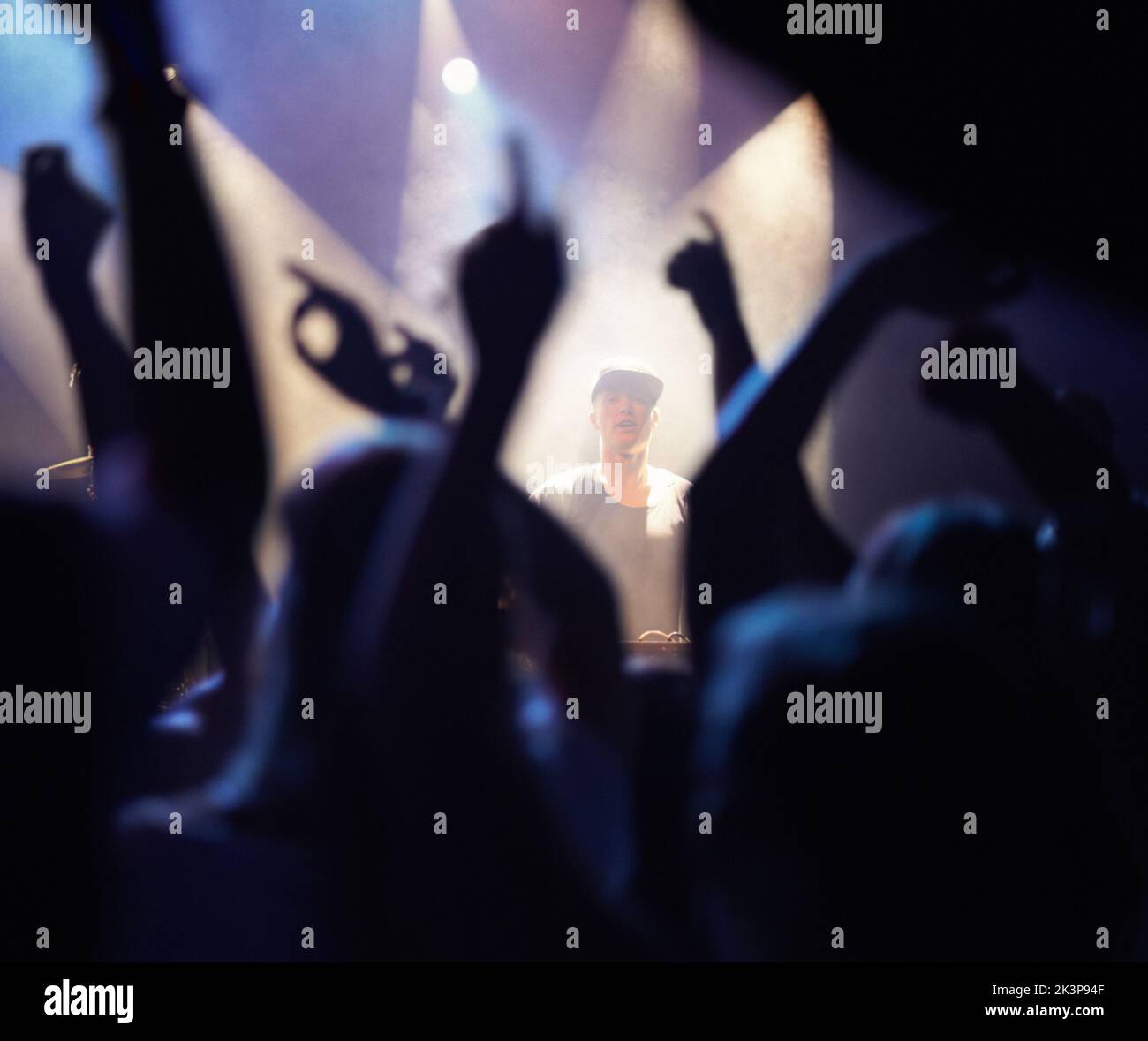 Working the crowd into a frenzy. A DJ working his audience into an ...