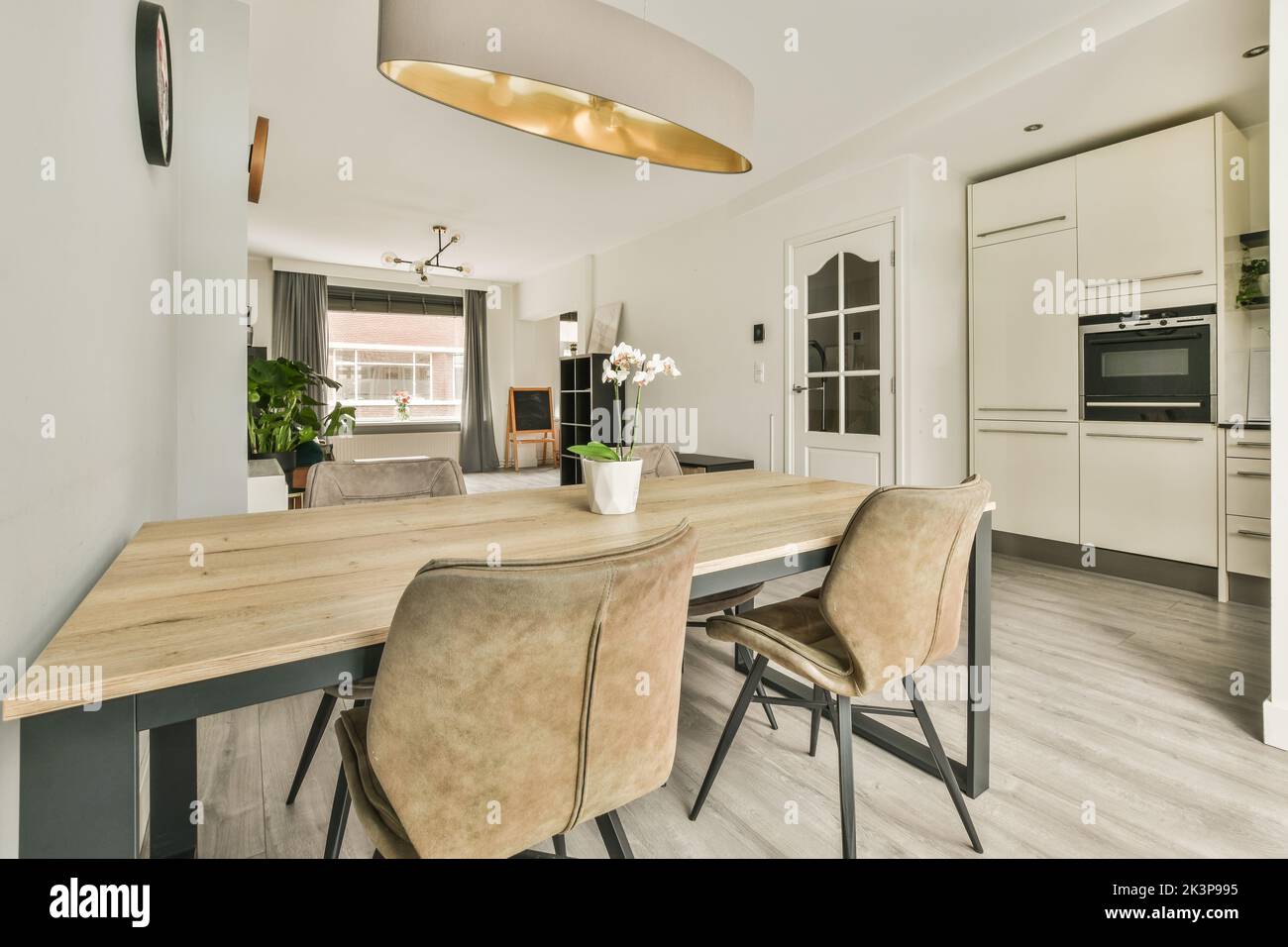 Couch and armchairs placed around table with decorations in dining area ...