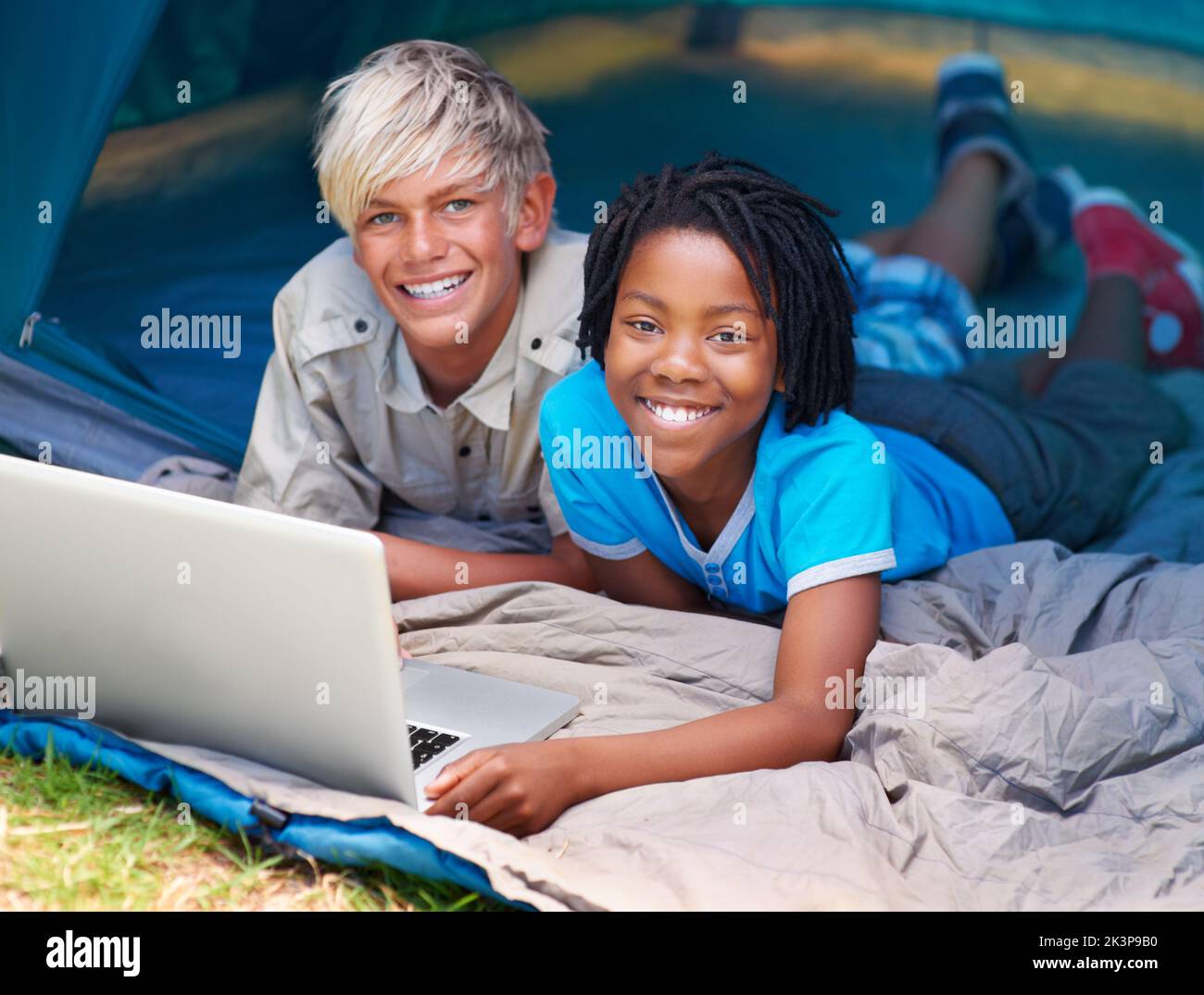 Wireless internet from inside their tent. Two young boys browsing the ...
