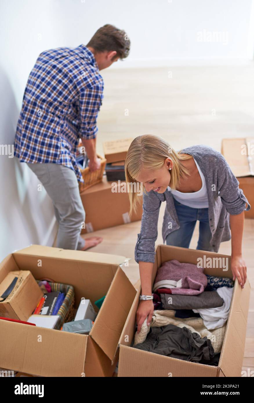 Thats the last of it. A young couple unpacking boxes in their new apartment after making the big ...