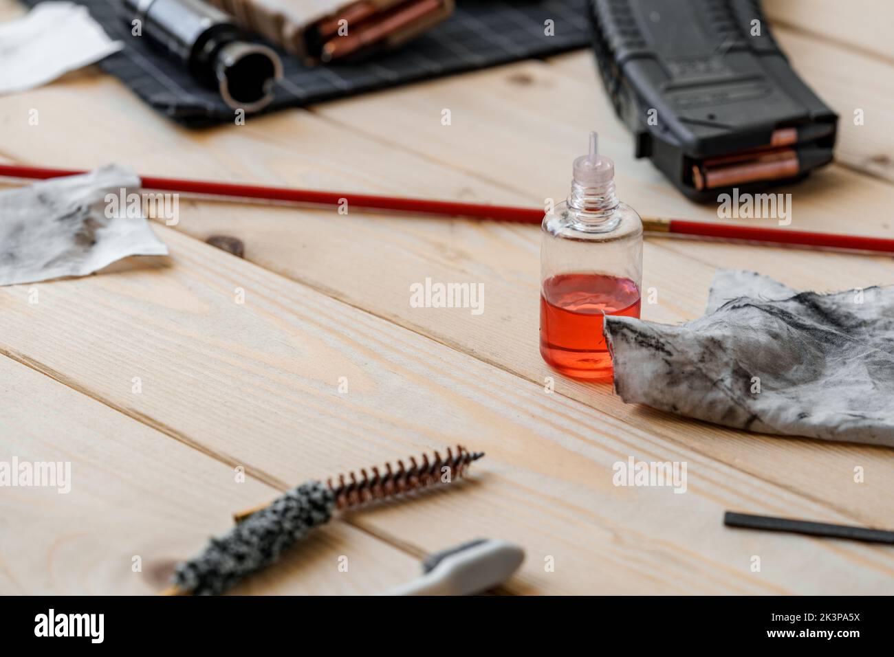 Disassembled rifle with cleaning tools on table of weapons workshop ...